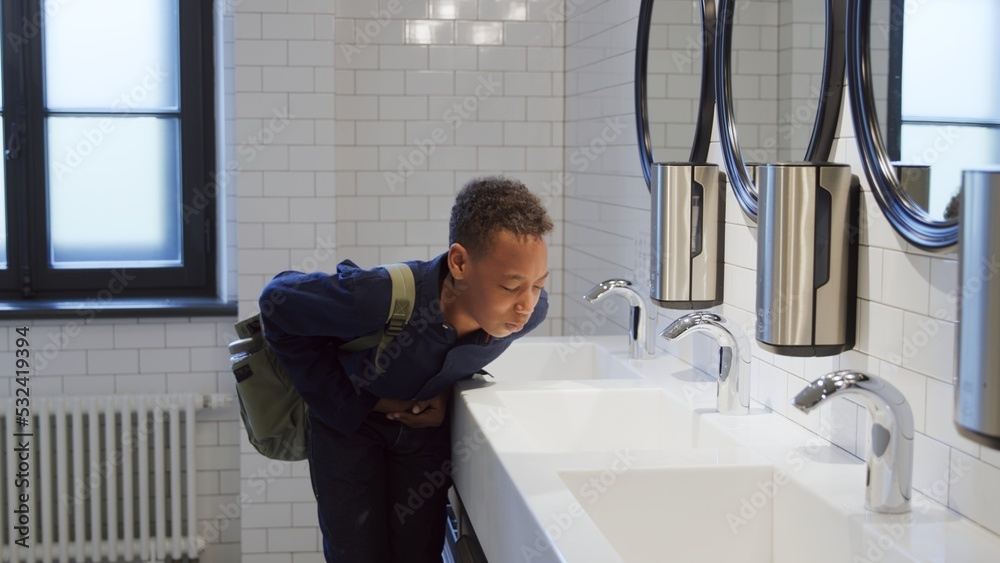 African-American teen student suffer from stomach ache having food ...