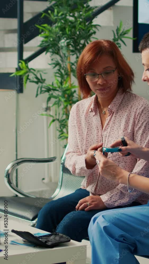 Vertical video: Diverse people doing diabetes examination with ...