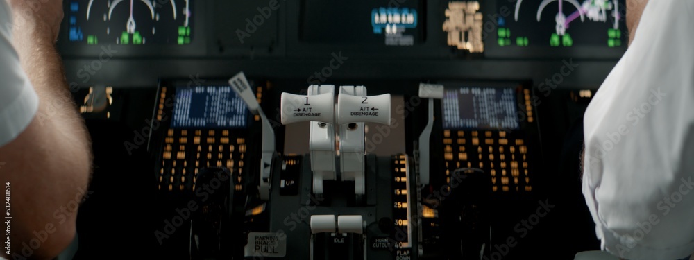 Commercial aircraft pilots controlling airplane throttle lever during ...