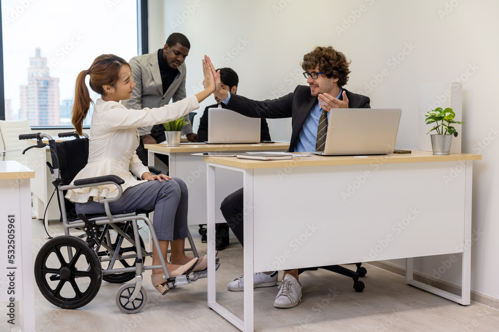 Foto de Handicap business woman giving high-five to colleague in ...