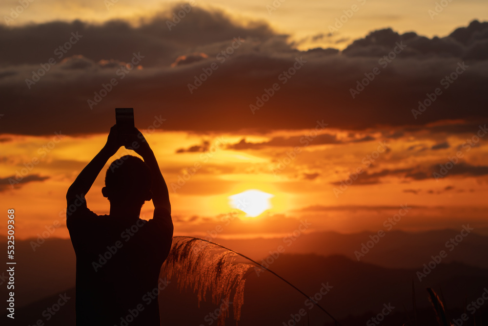 Silhouette of an old man watching beautiful lights during Twilight and ...