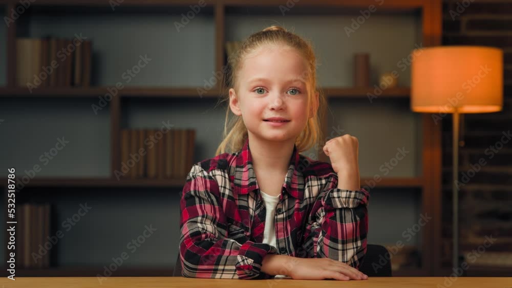 Overjoyed beautiful little young baby pupil in shirt posing clenching ...