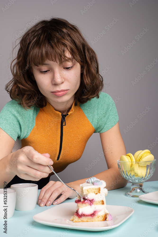 Birthday girl eating a pastel cake on a white and blue background Stock ...