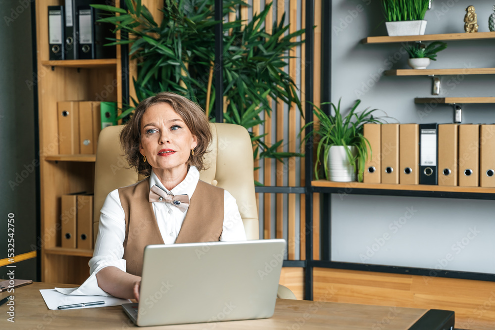 Confident stylish mature middle aged elderly woman in office.Workplace ...