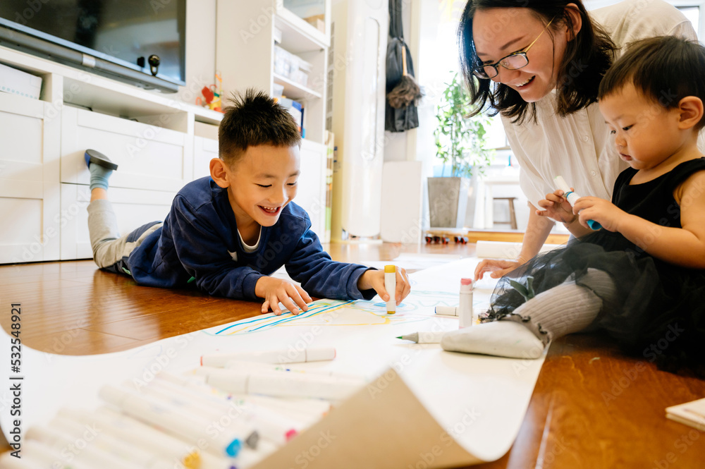 Mother and her children drawing at home Stock Photo | Adobe Stock