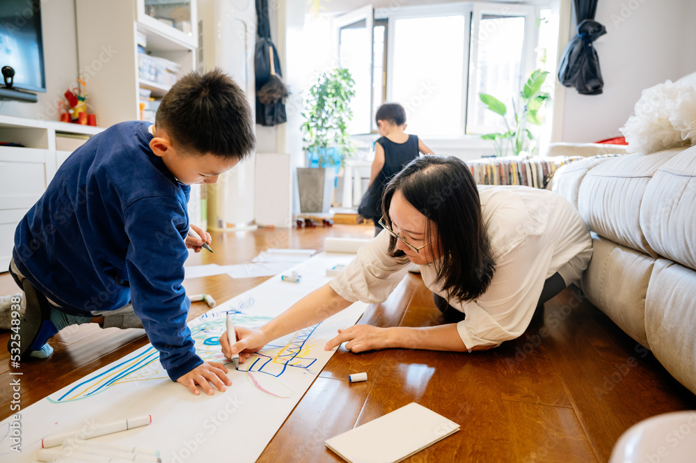 Mother and her children drawing at home Stock Photo | Adobe Stock