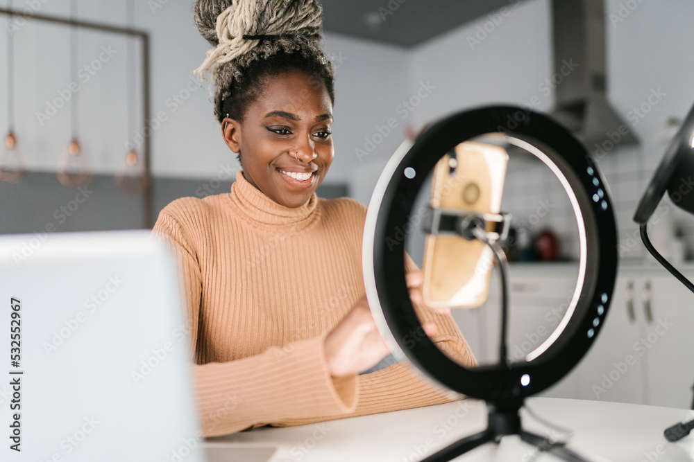 Black woman recording podcast on smartphone Stock Photo | Adobe Stock