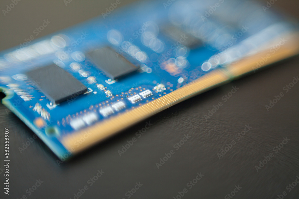 Computer memory chip placed on top of a black table. Connections and ...