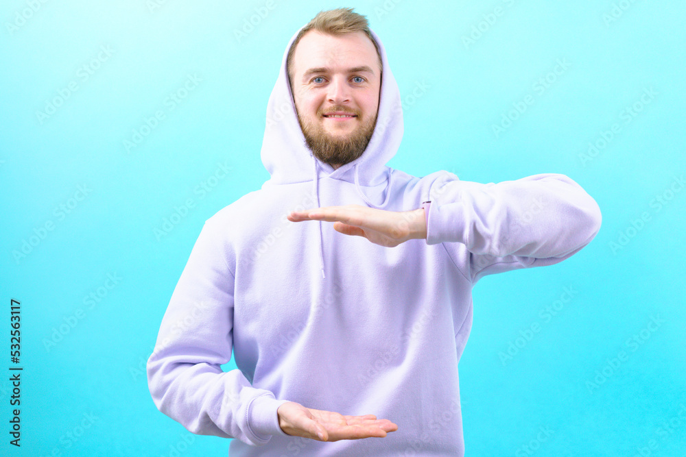 A brown hair man in purple hoodie holding an invisible object with both ...