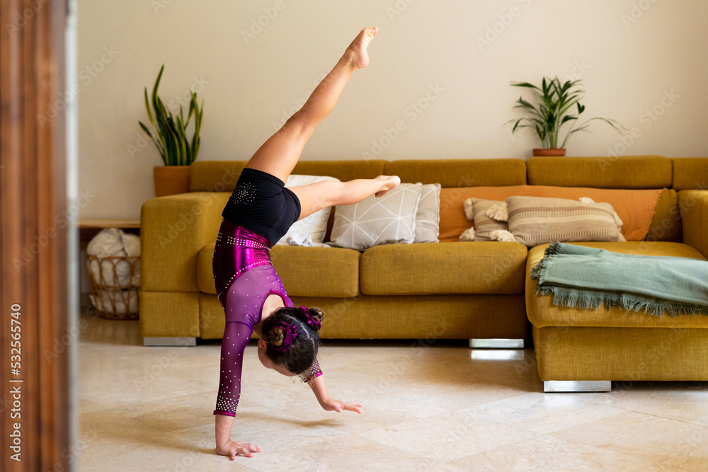 little girl practicing artistic gymnastics at home Stock Photo | Adobe ...