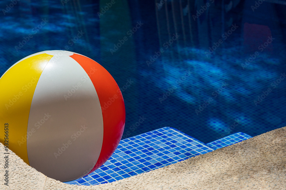Floating beach ball in a swimming pool Stock Photo | Adobe Stock