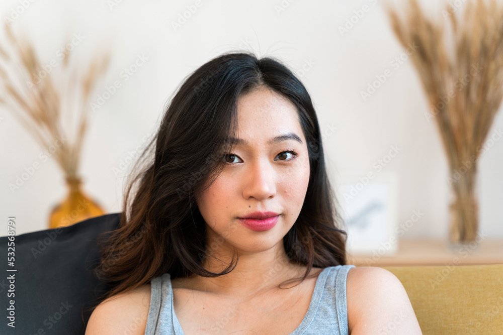 Portrait of an Asian woman at home. Stock Photo | Adobe Stock