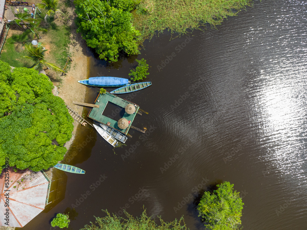 Foto de Aerial top view of a small wooden pier and some conoes in the ...