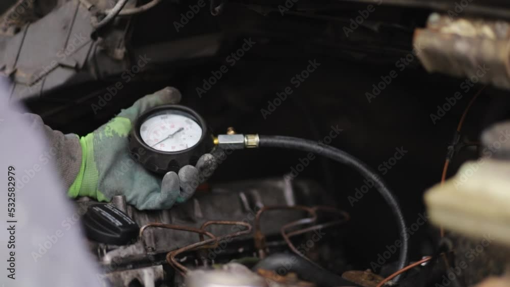 measurement of compression pressure in the cylinders of a car engine ...