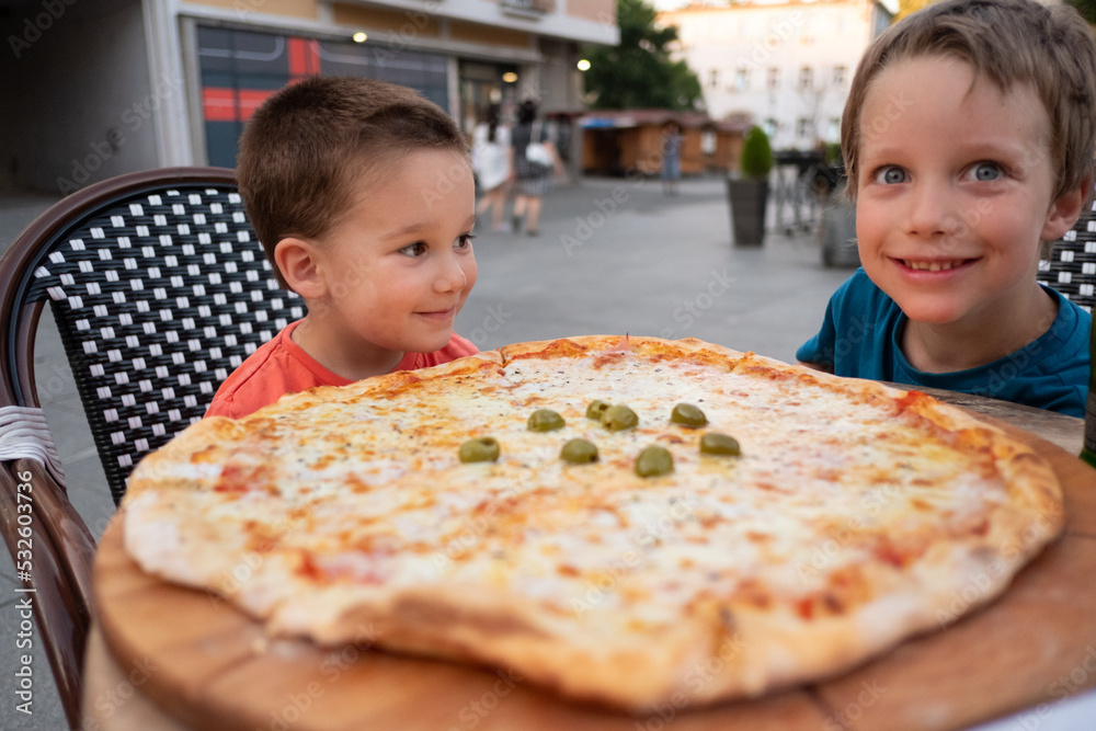 Happy kids in a pizza restaurant, parent point of view Stock Photo ...