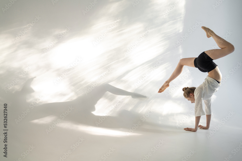 Female acrobat showing her capabilities in studio Stock Photo | Adobe Stock