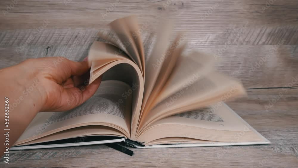 Turning pages in a white book close up slow mo. Reading a book ...