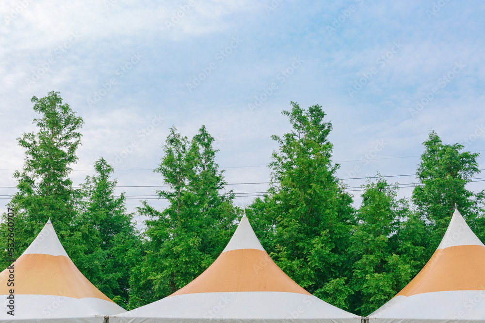Orange pop-up canopy installed next to street trees. Stock Photo ...