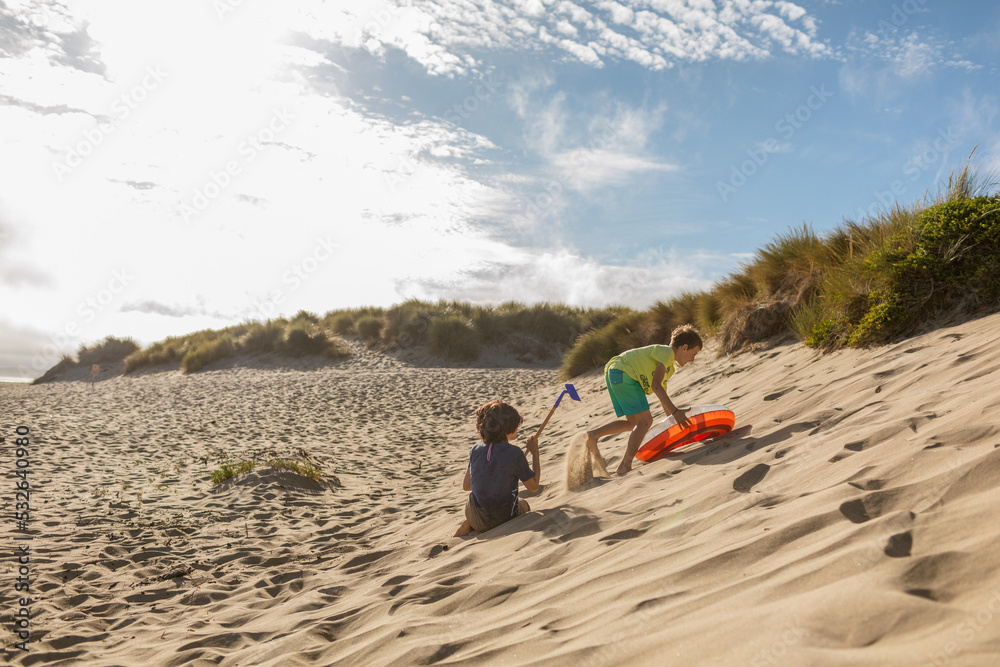 Two kids playing by dunes in summer Stock Photo | Adobe Stock