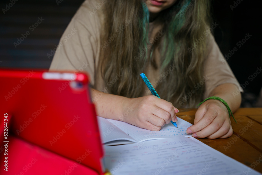 teen girl's hands doing homework using electronic tablet Stock Photo ...