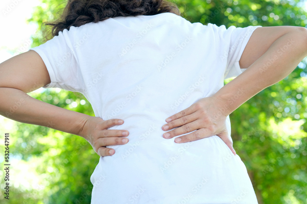 Woman's hand She is caught at the waist and her back is painful at the ...