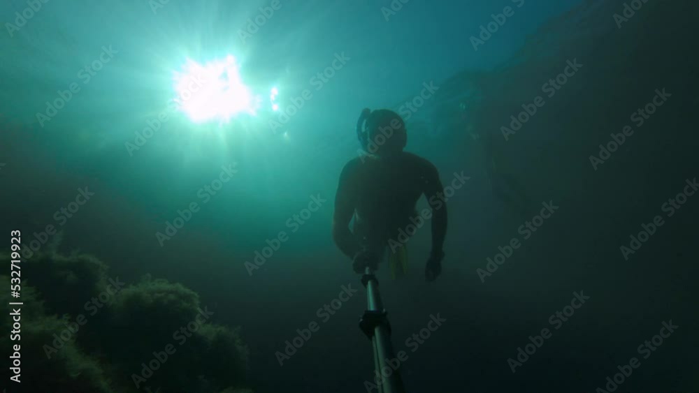 Underwater shooting Male friends are snorkeling underwater on a sunny ...