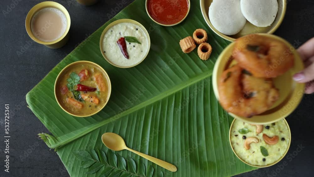 Medu Vada with tiffin sambar coconut chutney in banana leaf background ...