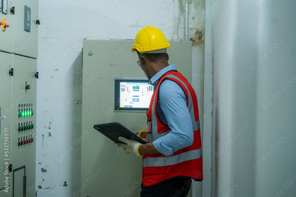 Engineer working in electrical control room,operator station network in ...
