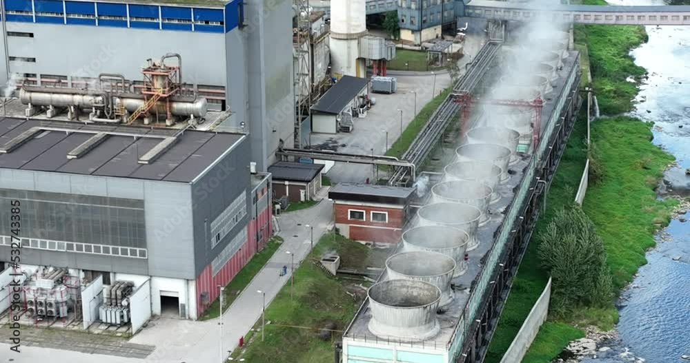 Aerial drone shot of coal power plant with two high cooling towers next ...