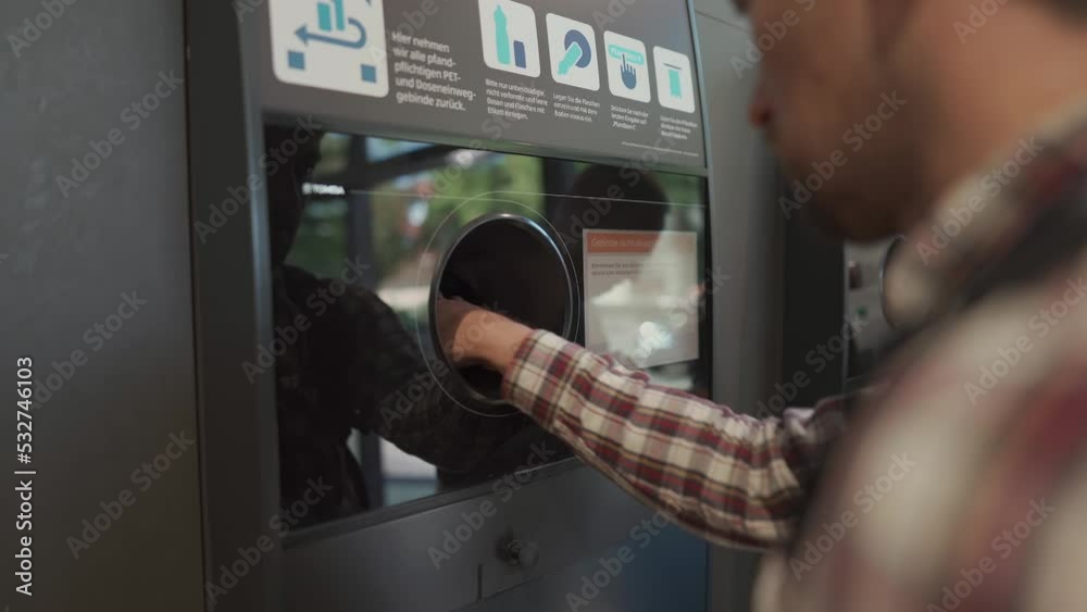 A man returns plastic bottles in a German supermarket. Reverse vending ...