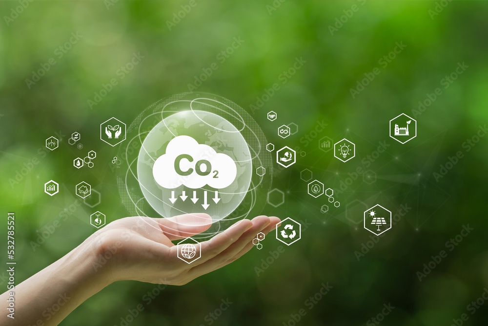 CO2 emission reduction concept.world icon in hand with environmental ...