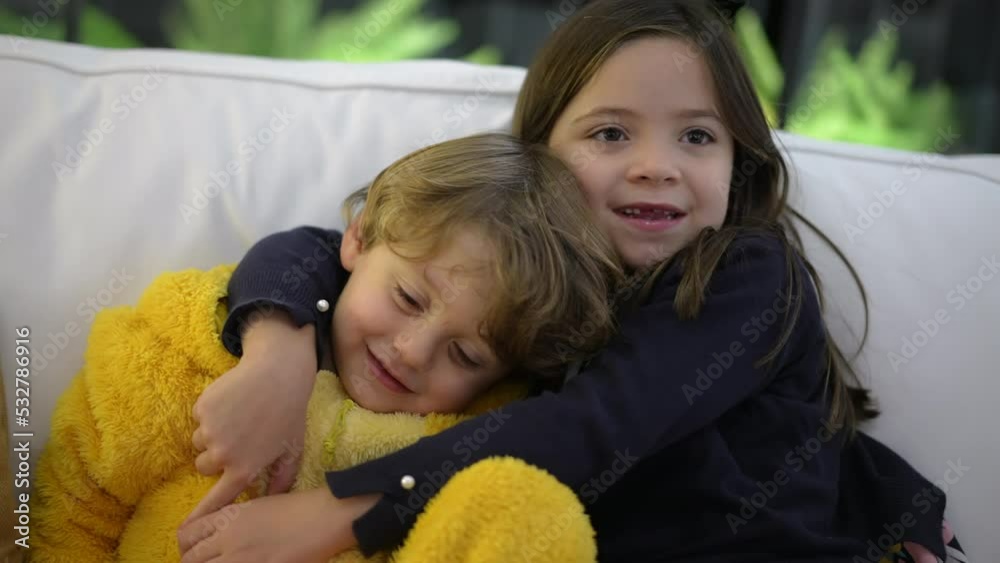 Happy little siblings posing for camera. Child sister embracing small ...