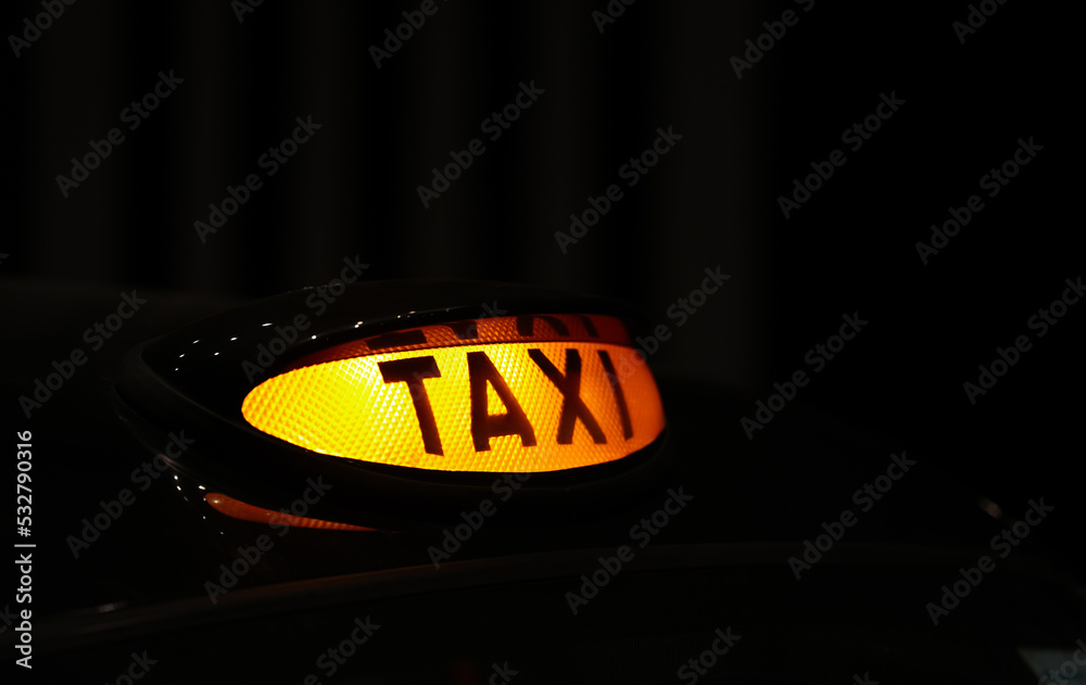 Taxi sign on top of a black cab in London, United Kingdom. Landmark ...