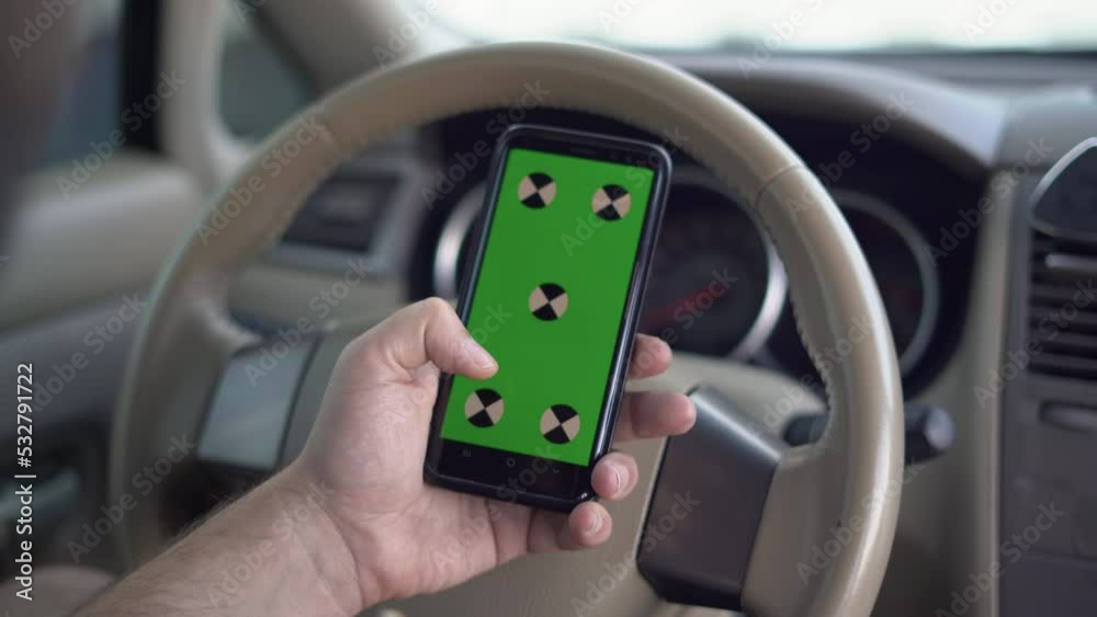 Man hand scrolling chroma key mobile phone with empty green screen in ...