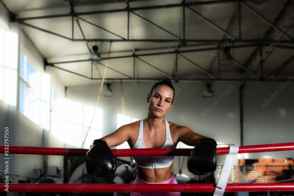 Young sweaty boxer woman or girl in the boxing ring future champion ...