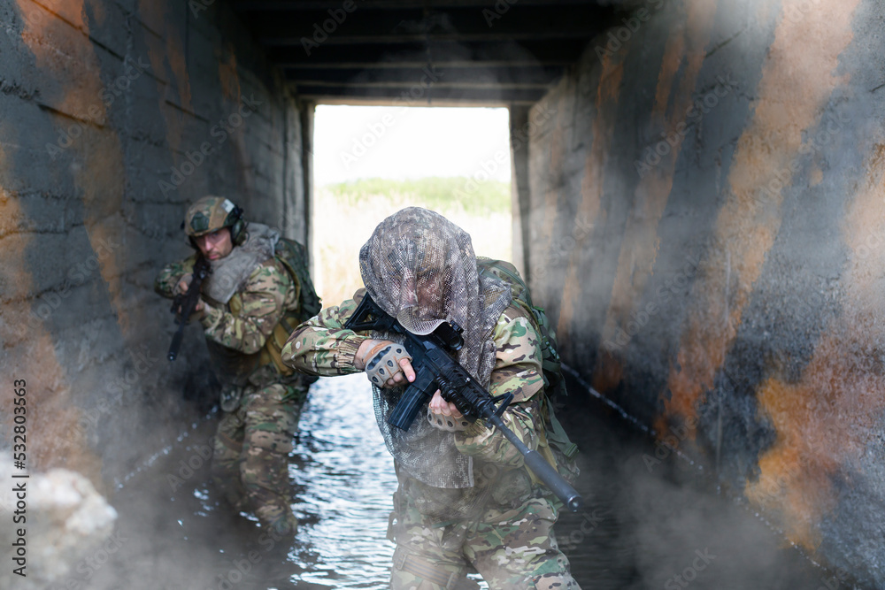 Two military mercenaries during special operation in underground bunker ...