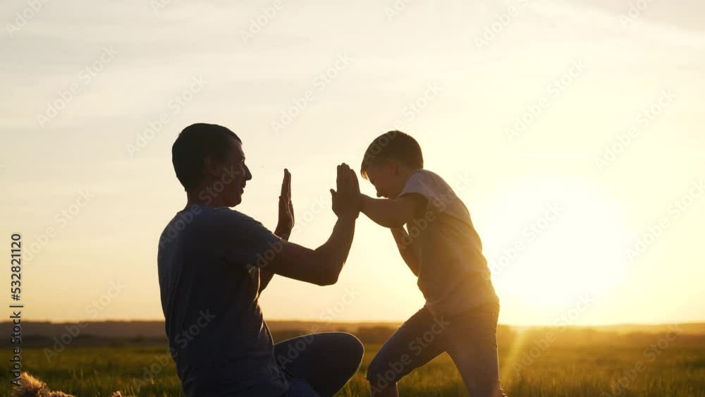 father and son boxing box silhouette at sunset. happy family in the ...
