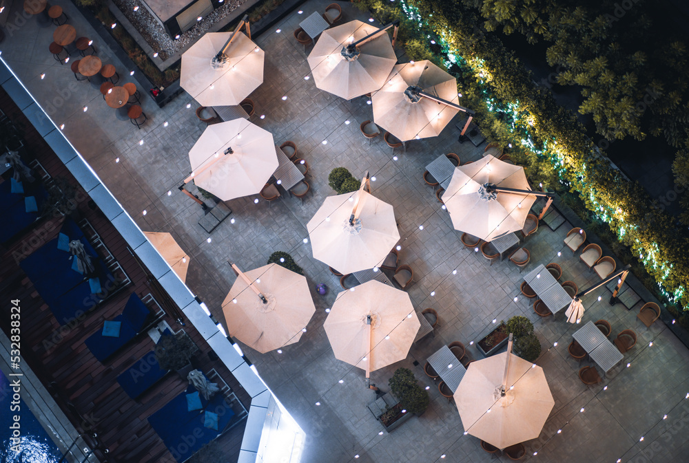 A night top view of an esplanade of a resort cafe or a restaurant with ...
