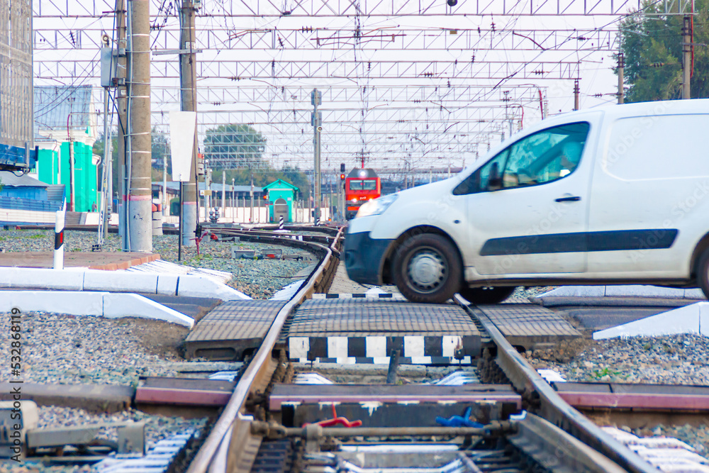 Commercial passenger car for on-time delivery crosses the railroad ...