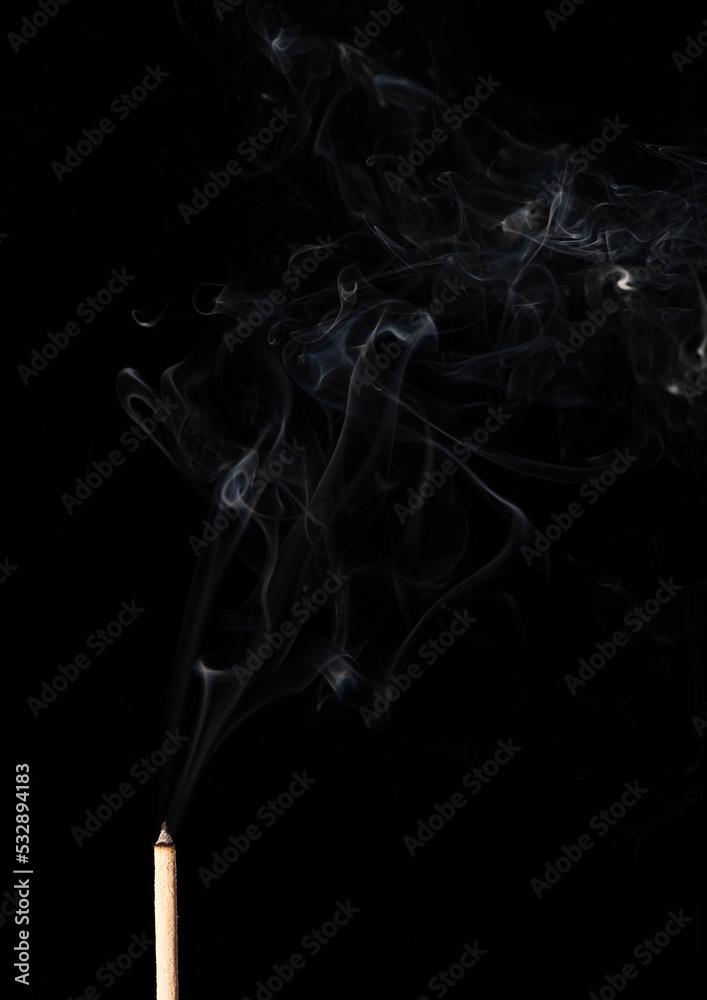 Temple incense sticks showing smoke trails and dramatic patterns due to ...