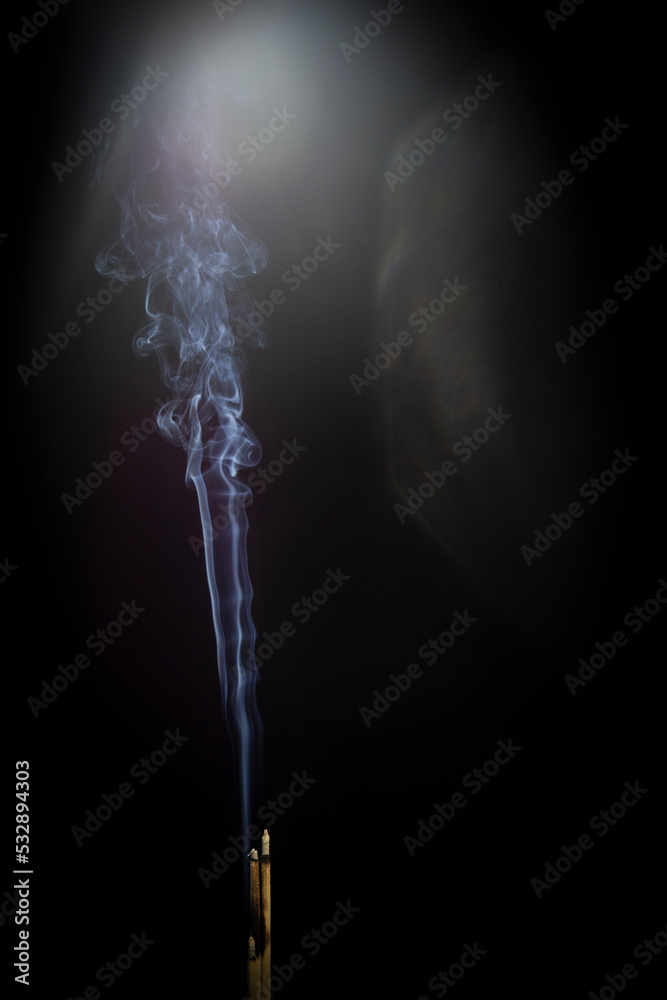 Temple incense sticks showing smoke trails and dramatic patterns due to ...