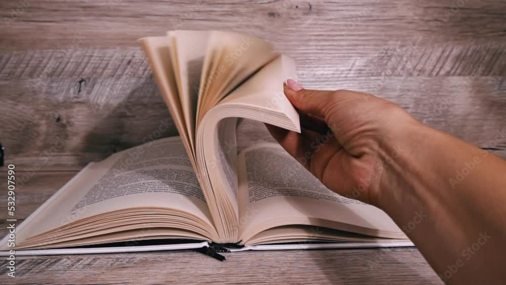 Turning pages in a white book close up slow mo. Reading a book ...