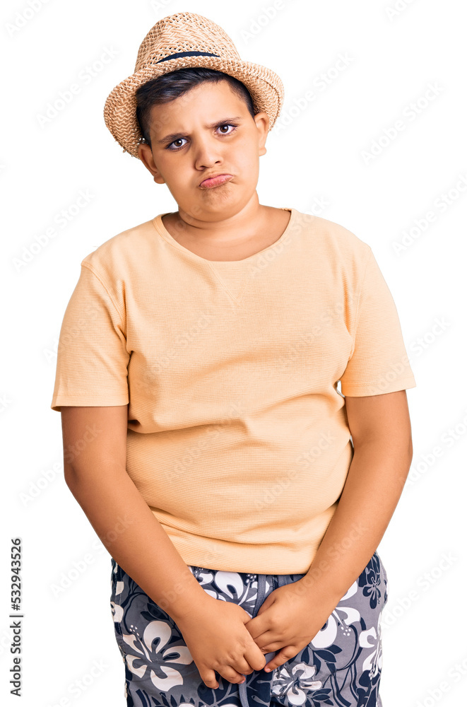 Little boy kid wearing summer hat and hawaiian swimsuit depressed and ...