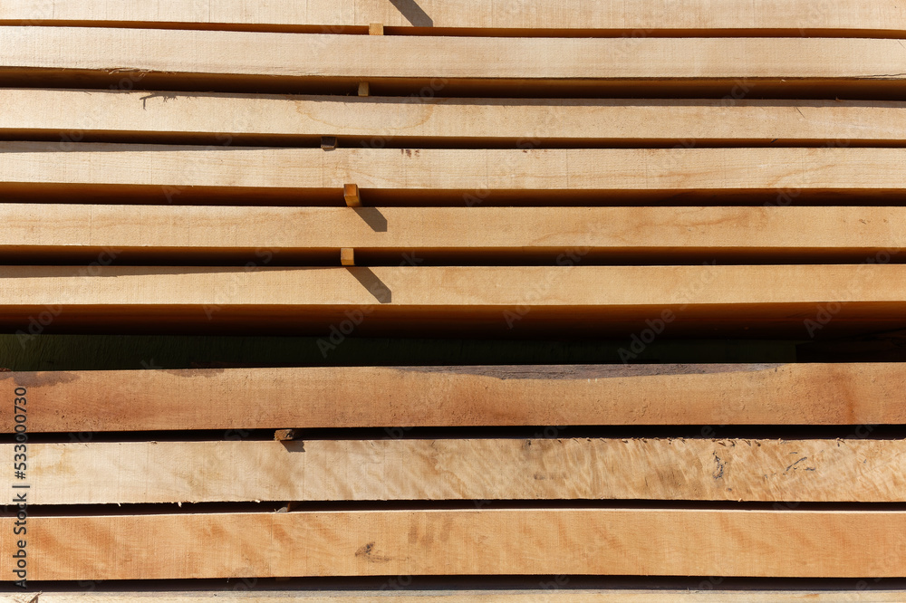Wood texture.Stack of wood planks on lumber yard. lumber industrial ...