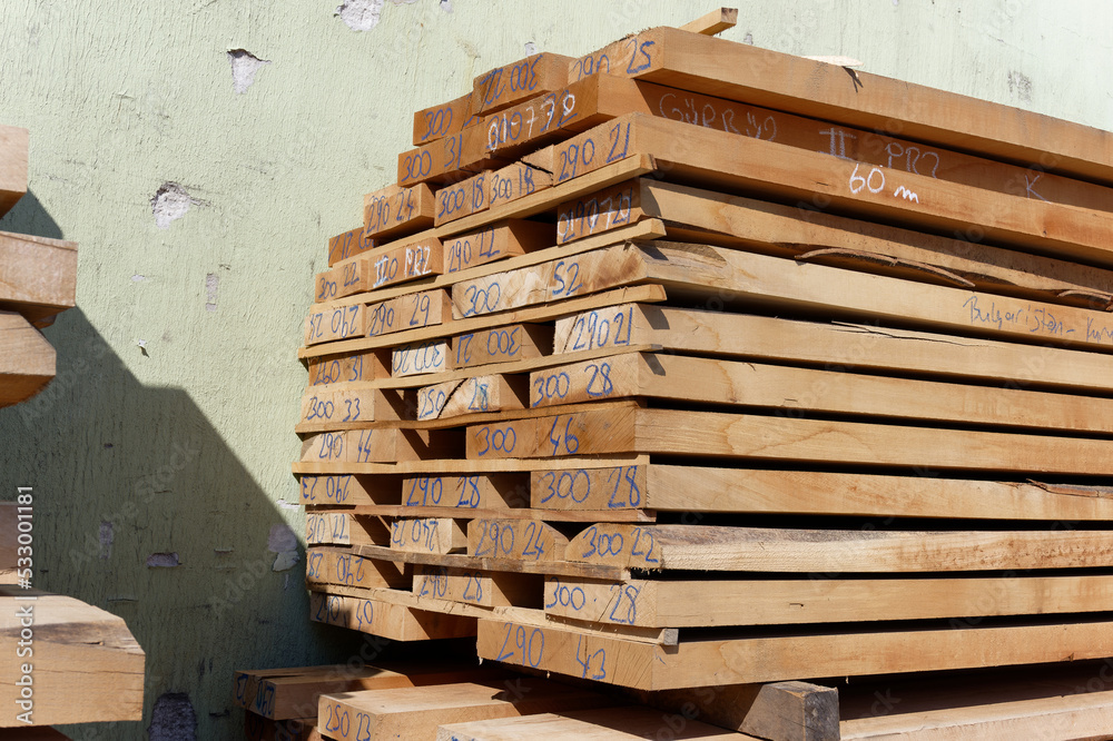 Wood texture.Stack of wood planks on lumber yard. lumber industrial ...