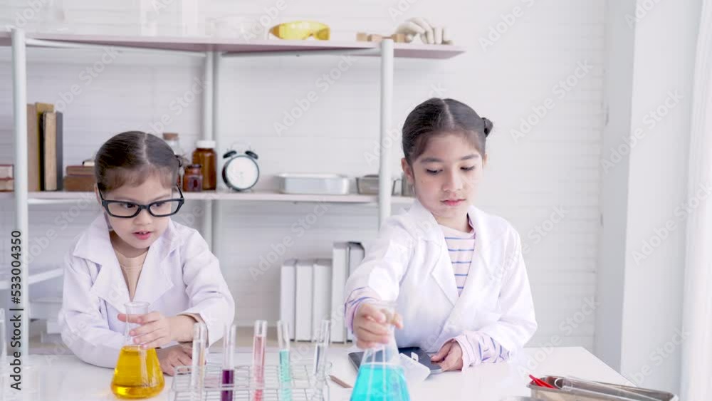 4K, Two little girls in the school lab, interested in a science ...