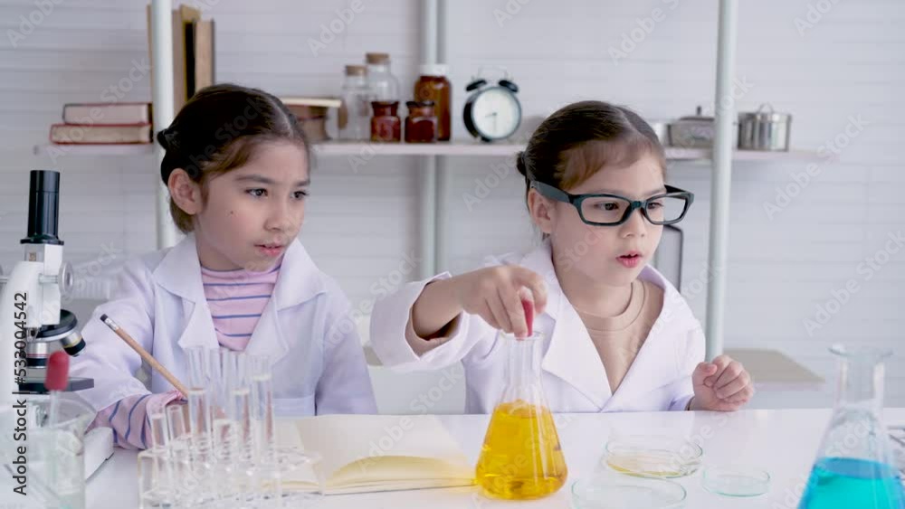 4K, 2 Cute girls taking on roles of little scientists having fun ...