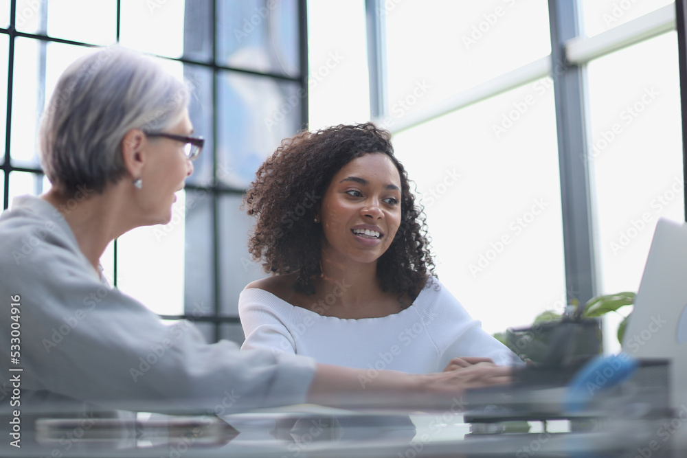 Female colleagues of different nationalities and ages met in the office ...
