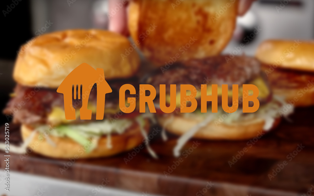 GRUBHUB Logo is shown in front of delivered tasty burgers, online food ...