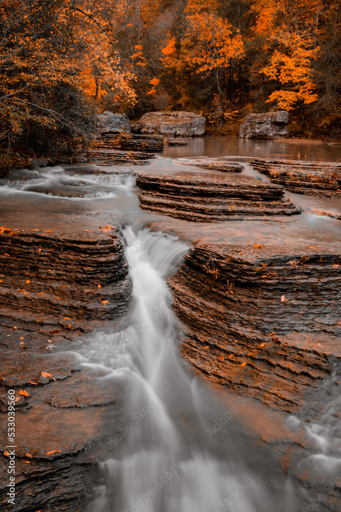 Fotka „Six finger falls a unique cascade waterfall flows over rocks at ...